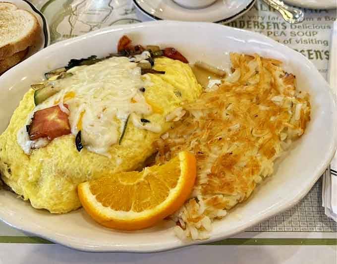 A veggie omelet with hash browns that'll fuel your journey, served on plates reminding you where you are.