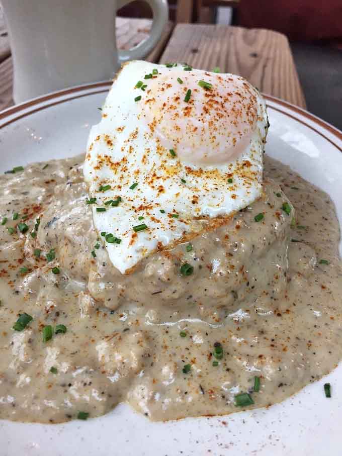 That pool of sausage gravy isn't subtle, and neither is the flavor bomb waiting beneath that perfect biscuit.