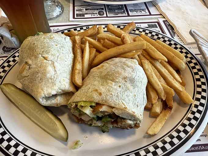 A wrap stuffed with enough ingredients to require architectural support, served with fries that know their golden purpose.