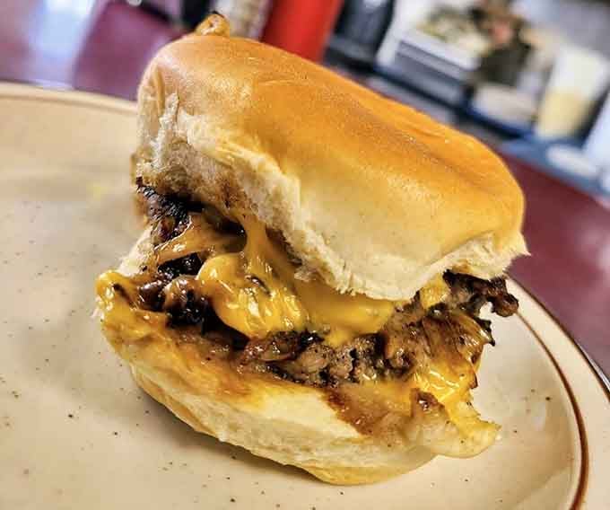 That melted cheese cascading over a thin patty is basically edible gold, minus the dental work afterward.