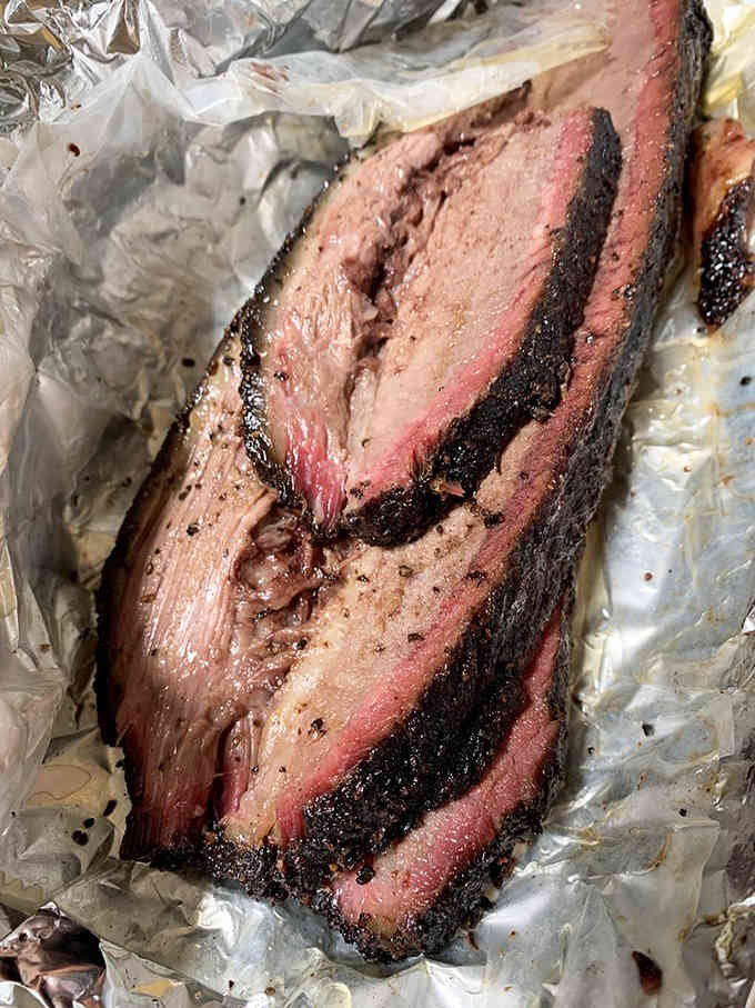 That pink smoke ring and dark bark tell you everything you need to know about serious barbecue craftsmanship.