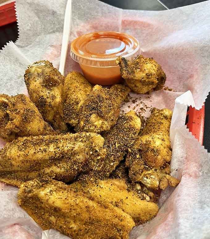 Cajun wings so generously coated, they look like they've been rolling around in a spice factory explosion.