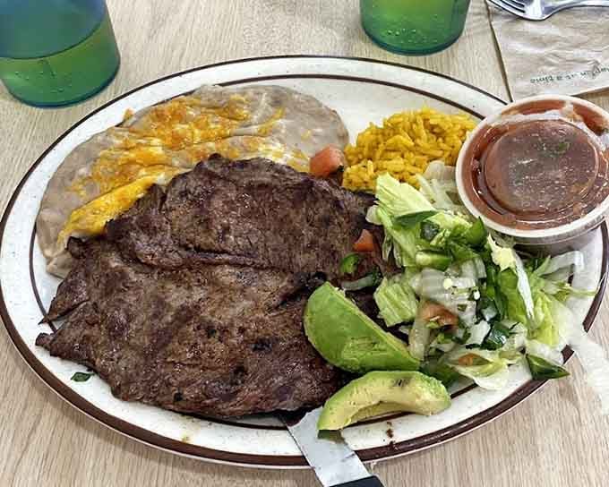 Carne asada with eggs, rice, beans, and salad proves breakfast can be both hearty and balanced.
