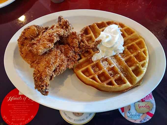 Chicken and waffles with that golden crispy coating and whipped cream proves some food combinations are pure genius, no debate needed.