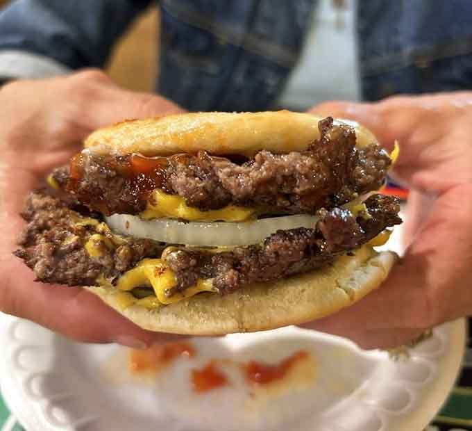 This double cheeseburger means business, stacked high with perfectly melted cheese and seasoned beef patties done right.