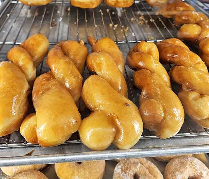These twisted glazed donuts look like they're doing yoga, and honestly, they're more flexible than most of us.