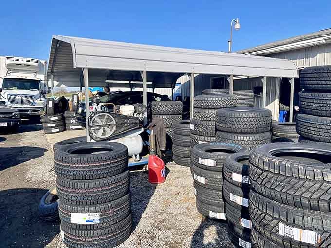 Tires stacked high under covered spaces, because practical purchases and vintage finds coexist beautifully at this market.