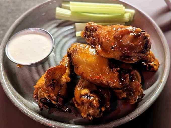 Wings glazed to perfection, served with celery because someone still believes in vegetables at restaurants like this.