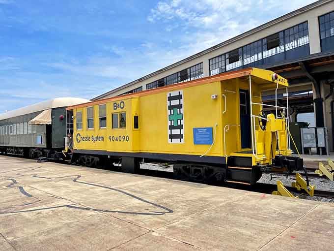 That bright yellow caboose outside proves the museum's train station roots run deeper than nostalgia alone.