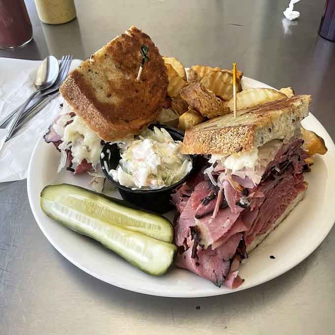 This isn't just a sandwich, it's architectural achievement between two slices of perfectly grilled rye bread.