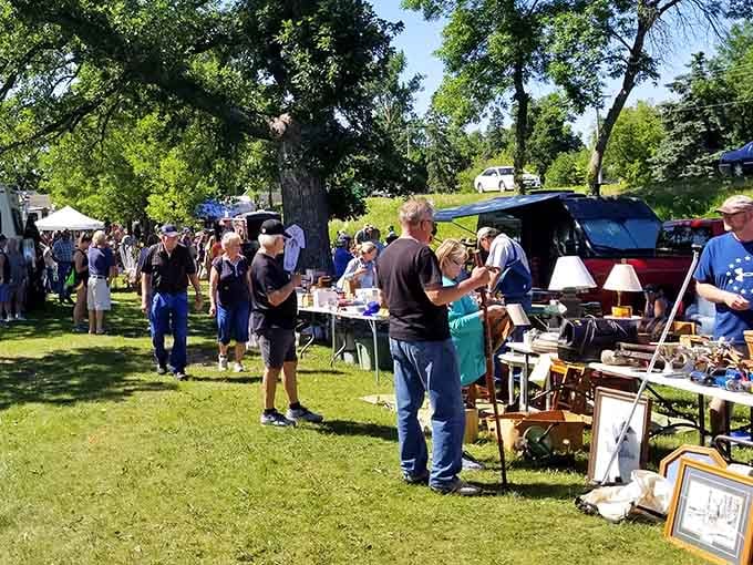 Weekend warriors and serious collectors converge under shady trees, united in their quest for that perfect unexpected discovery.