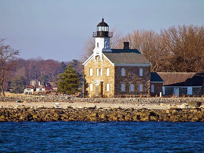 Approaching by water, the lighthouse emerges like something from a New England postcard come to life.