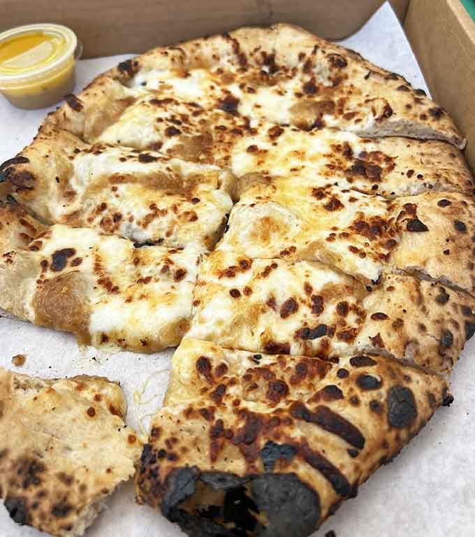 Golden, blistered cheese bread that stretches like your favorite childhood memories, only better and more delicious now.