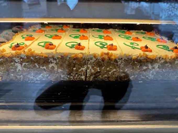 That towering carrot cake slice reveals layers of moist perfection that would make Bugs Bunny weep with envy.