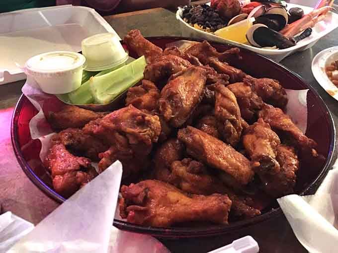 These smoked wings arrive piled high with celery sticks, ready to redefine your entire understanding of poultry perfection.