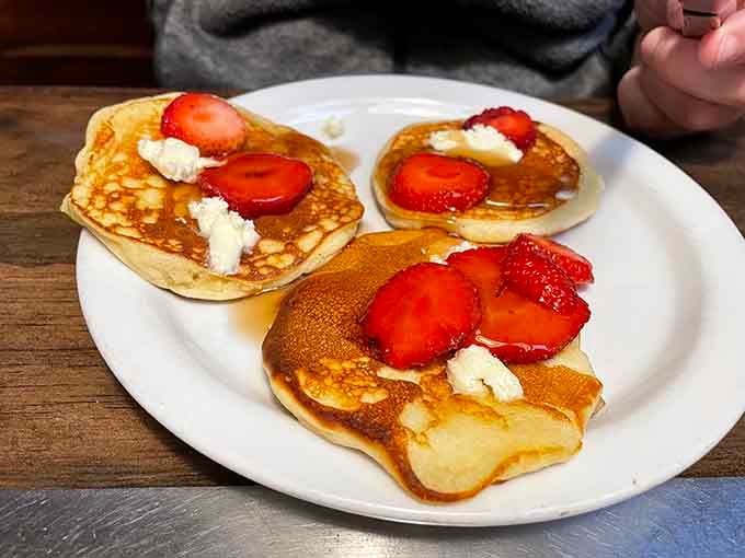 Fresh strawberries and dollops of cream transform simple pancakes into edible art you almost hate to disturb.