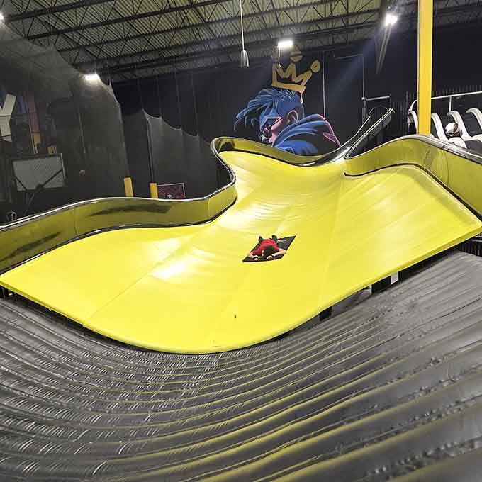 Watch kids zoom down these massive slides like they're training for some kind of extreme indoor Olympics.