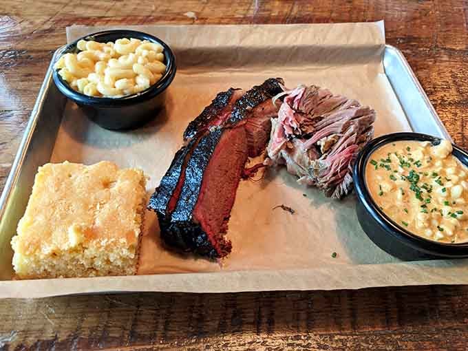 Brisket, pulled pork, mac and cheese, and cornbread unite on one tray for the ultimate comfort food summit.