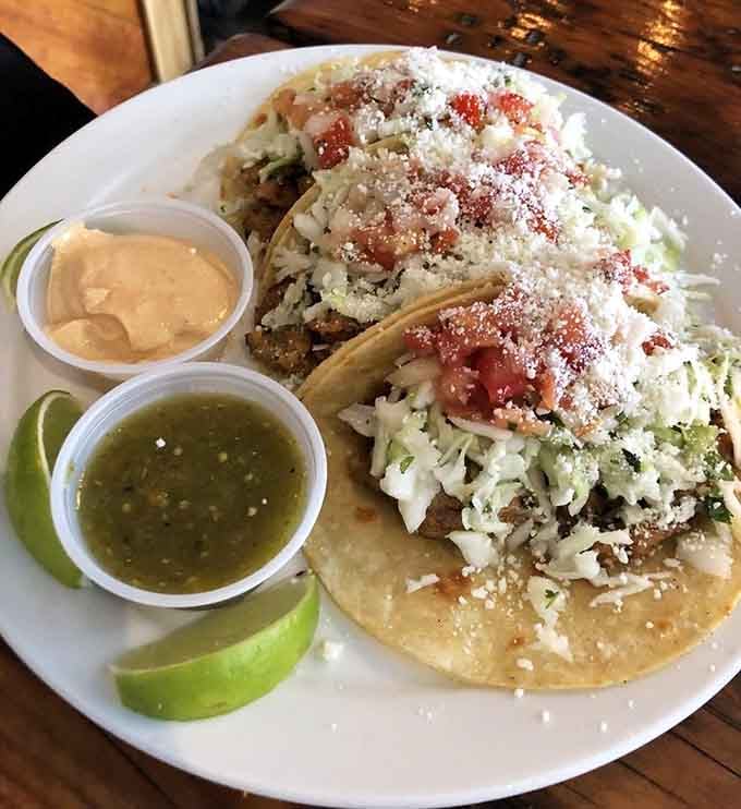 Fish tacos piled high with all the good stuff, because moderation is overrated when it's this fresh.