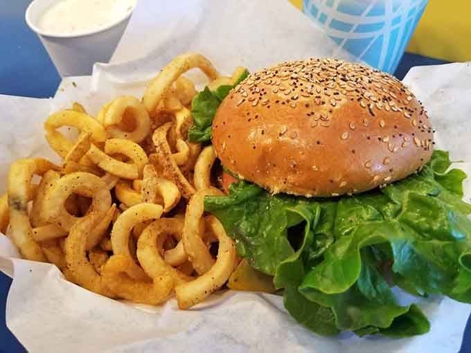 That sesame-studded bun and pile of crispy onion rings prove Splash Caf&eacute; knows its way around landlubber food too.
