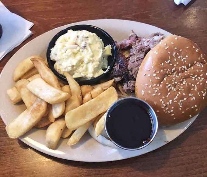 That sesame seed bun is working overtime to contain all that smoky, tender pulled pork perfection.
