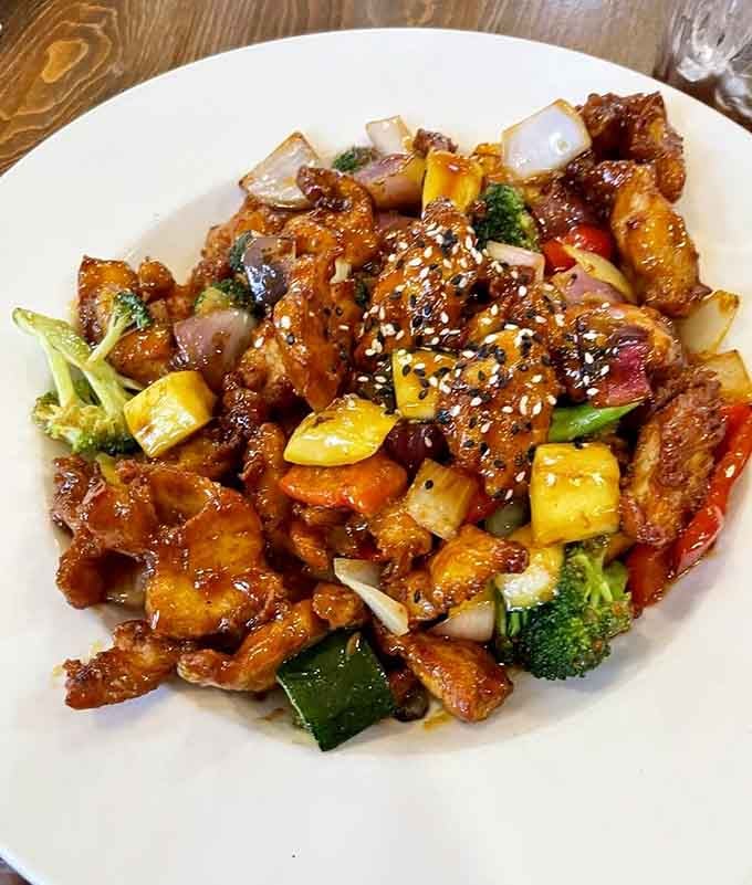 Asian sesame chicken with vegetables that proves this kitchen takes its food as seriously as its beer selection.