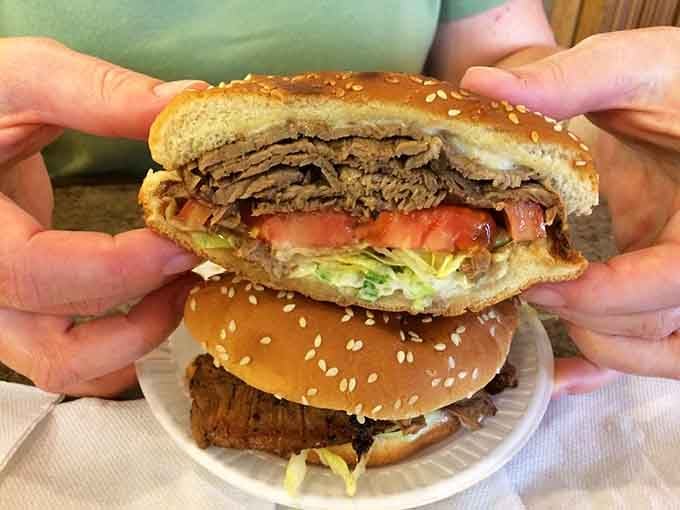The cross-section reveals layers of perfectly seasoned beef that would make any burger enthusiast weep with joy.