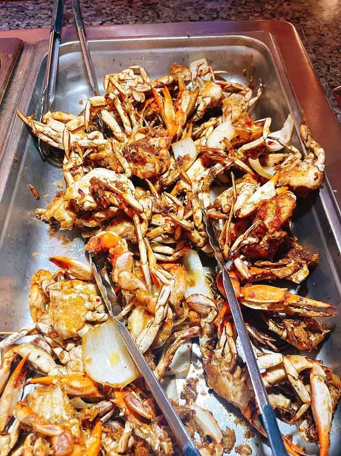 Garlic butter crab legs piled high like edible treasure, ready to test your shell-cracking skills and patience.