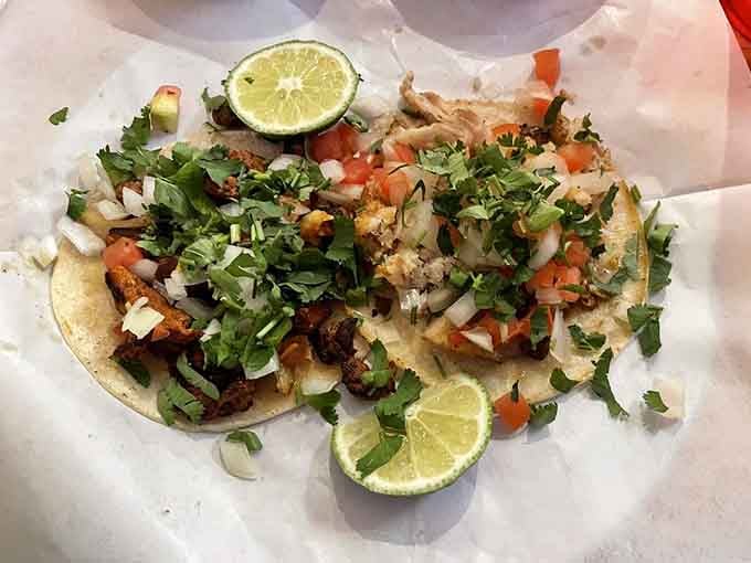 Tacos piled high with fresh toppings and lime wedges—this is what happiness looks like on a tortilla.