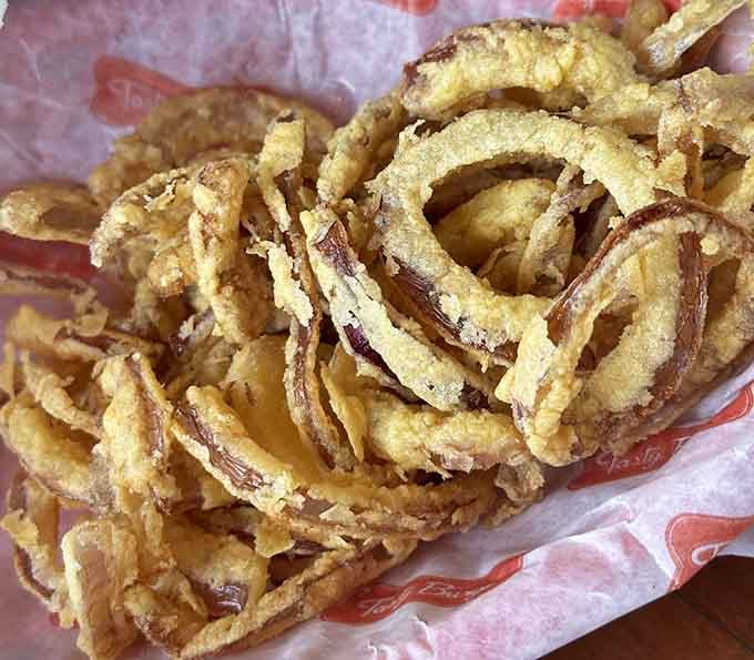 These aren't your sad cafeteria onion rings; they're thick, crispy circles of pure fried joy and commitment.