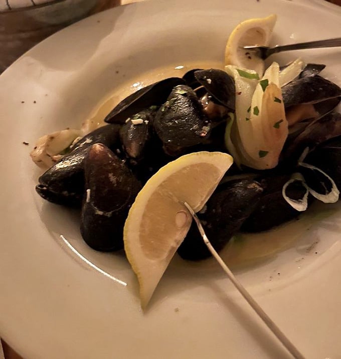 Steamed mussels swimming in garlic butter broth that'll have you contemplating the meaning of life and ordering extra bread.