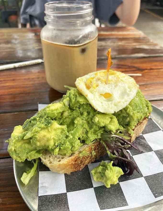 That mountain of avocado topped with a perfectly fried egg is basically California dreaming on a Florida plate.