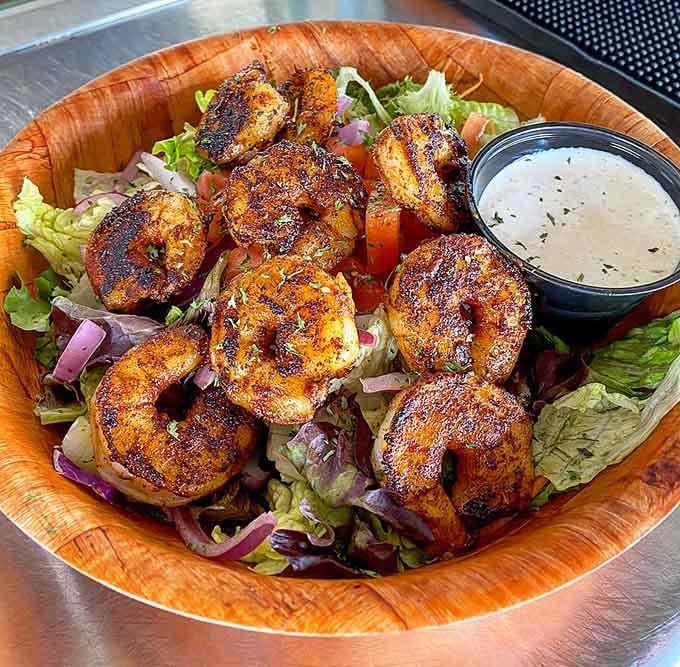 Blackened shrimp over fresh greens with creamy dressing makes salad feel less like a punishment and more like a celebration.