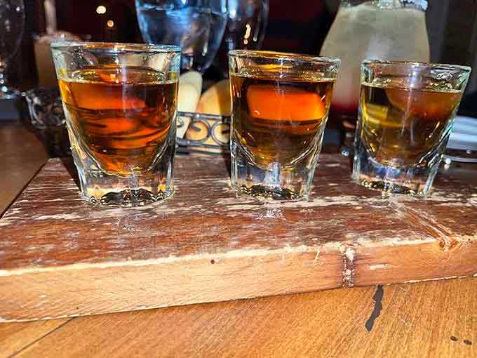 A bourbon flight served on wood because sometimes you need options before committing to the good stuff.