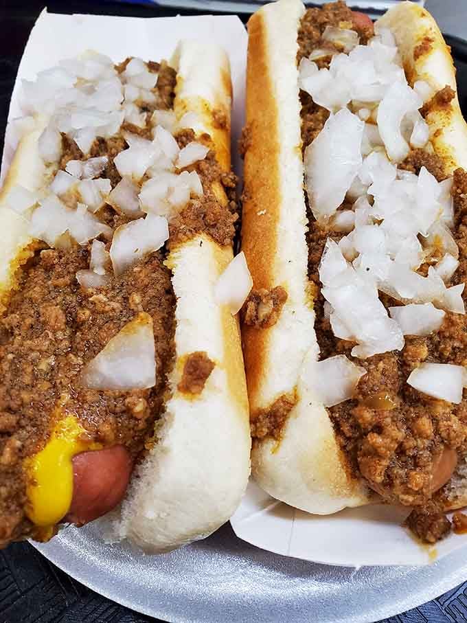 Two chili dogs topped with chopped onions prove that sometimes simple perfection needs no fancy introduction or apology.