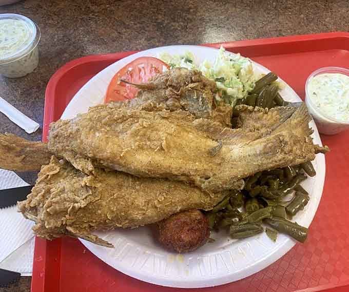 Golden catfish that could feed a family, served with sides that respect the Southern tradition of never leaving hungry.