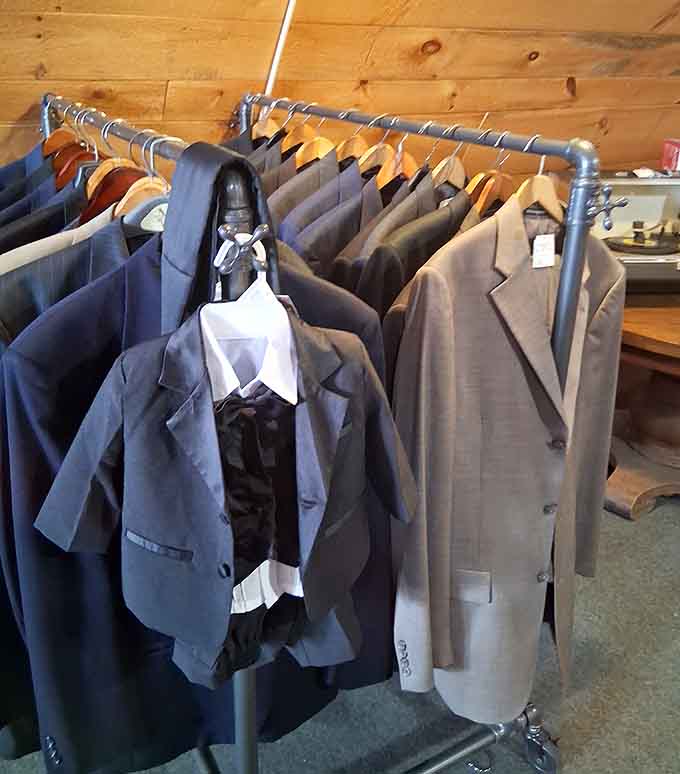 Men's suits lined up like they're waiting for their next big moment, decades of style on display.