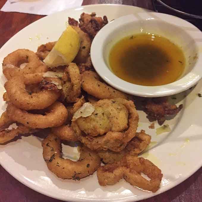 Golden, crispy calamari with garlic butter dipping sauce - proof that good things really do come from the sea.
