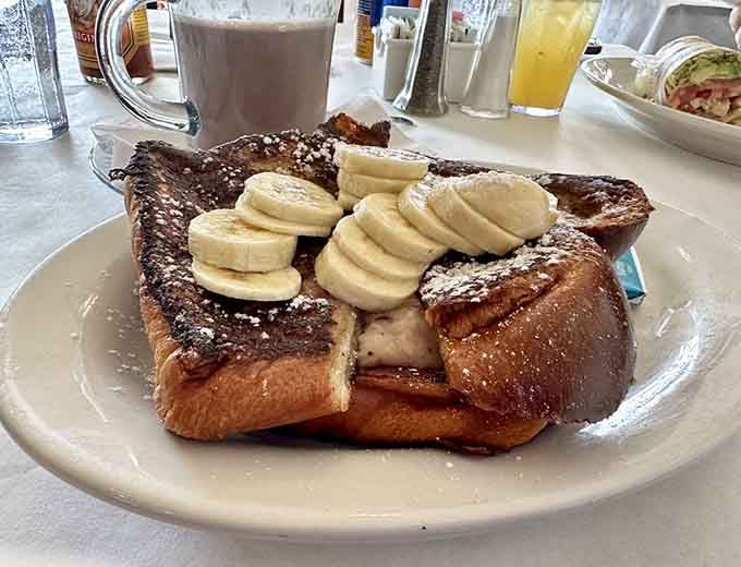 French toast topped with bananas and powdered sugar, because some mornings demand a standing ovation.