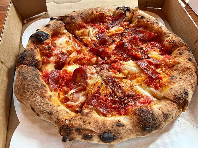 The char marks on that Soppressata pizza aren't mistakes, they're badges of wood-fired honor and flavor.