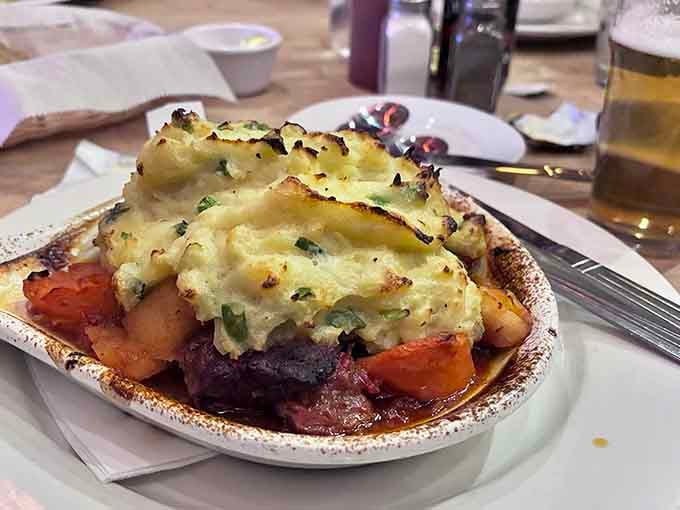Shepherd's pie so hearty it could probably shepherd actual sheep, topped with perfectly browned mashed potatoes that dreams are made of.