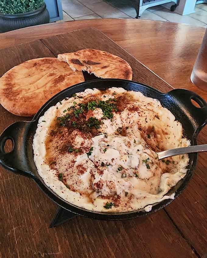 Whipped feta arrives in a cast-iron skillet like comfort food decided to get fancy and sophisticated.