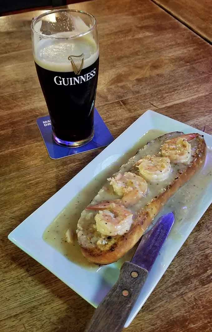 Shrimp nestled on garlic bread with a Guinness alongside proves some pairings are simply meant to be together.