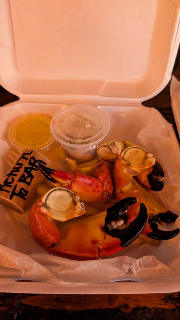 Stone crab claws with mustard sauce and crackers, the kind of meal that makes Florida winters worth celebrating.