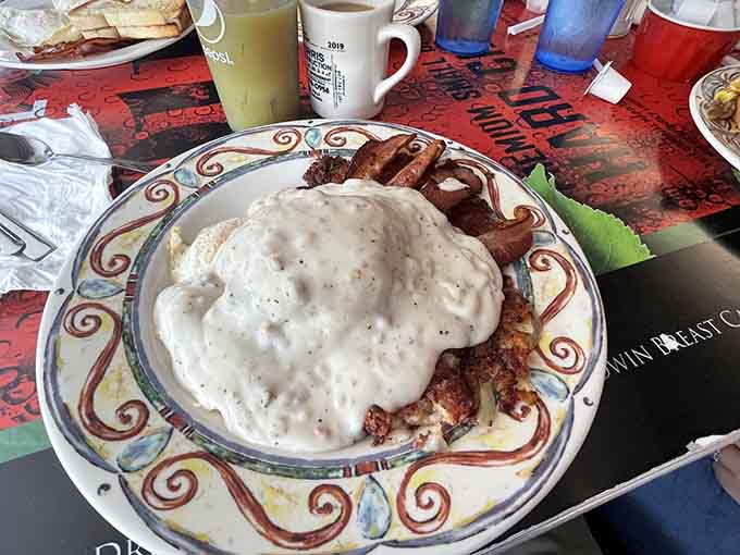 Hash browns buried under gravy with bacon standing guard like delicious sentries at The Gem Diner.
