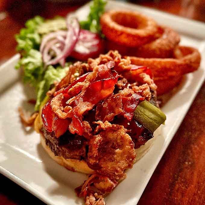 When bacon meets BBQ sauce on a burger, you're witnessing culinary magic that defies gravity and good manners.