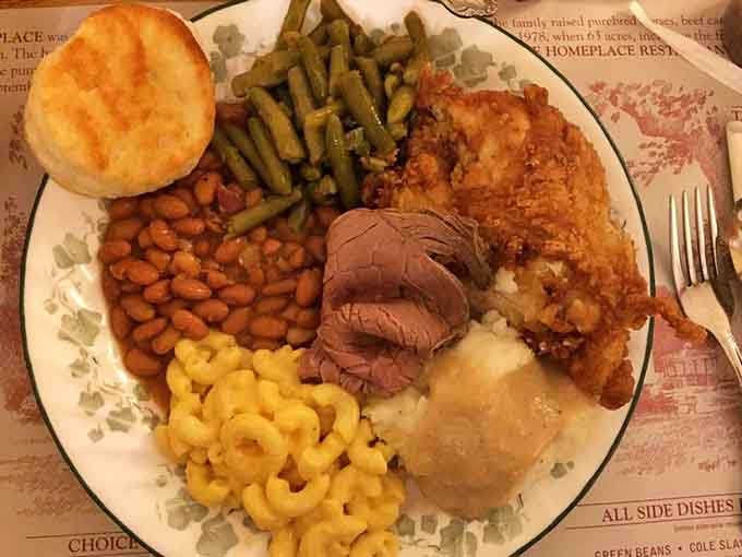 One plate somehow holds fried chicken, roast beef, ham, and enough sides to feed a small village happily.