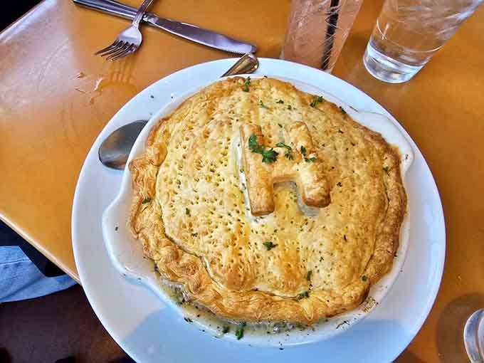 The Chicken Pot Pie arrives with a golden crust that could make your grandmother weep with jealous pride.