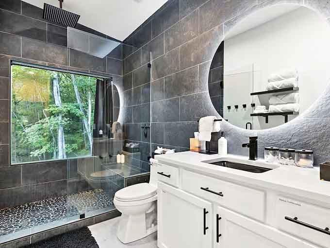 Sleek gray tiles and spa-like fixtures prove that quirky exteriors can hide seriously luxurious bathrooms within their walls.