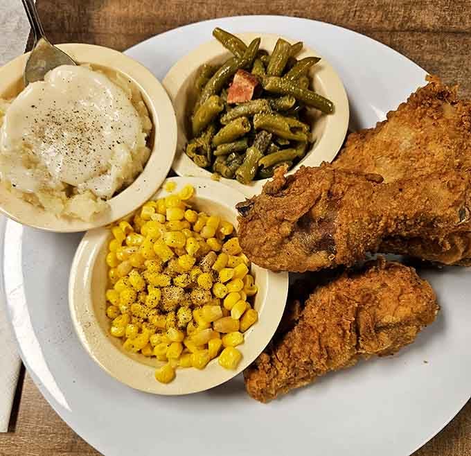 Golden fried chicken with mashed potatoes, corn, and green beans proves simple done right beats fancy every time.